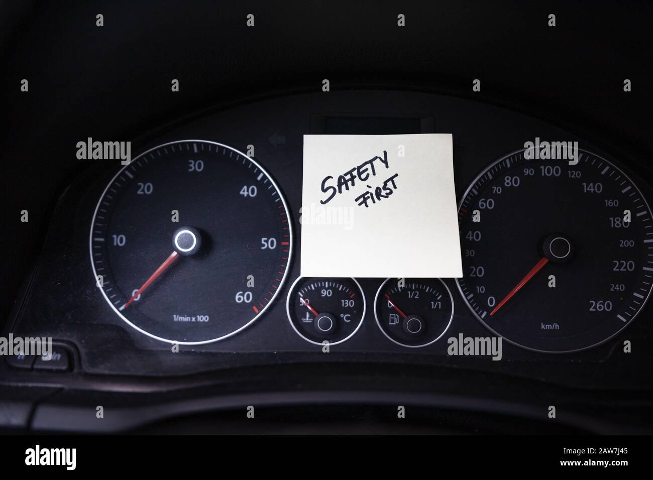 Writing safety first on memo post reminder. Text on sticky paper inside ...