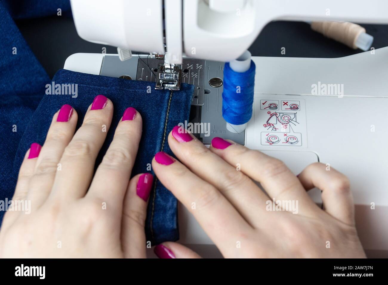 the process of tailoring, woman's hands with a cloth on the sewing ...