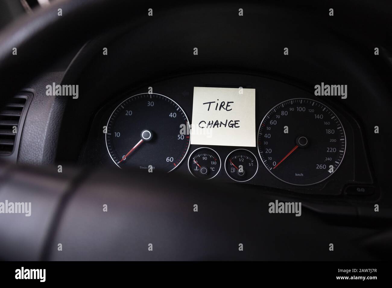 Writing tire change on memo post reminder. Text on sticky paper inside ...
