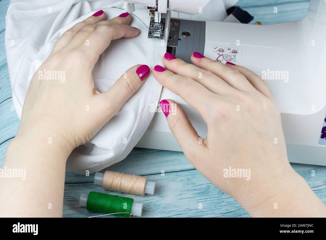 Womans hand sewing on machine hi-res stock photography and images - Alamy