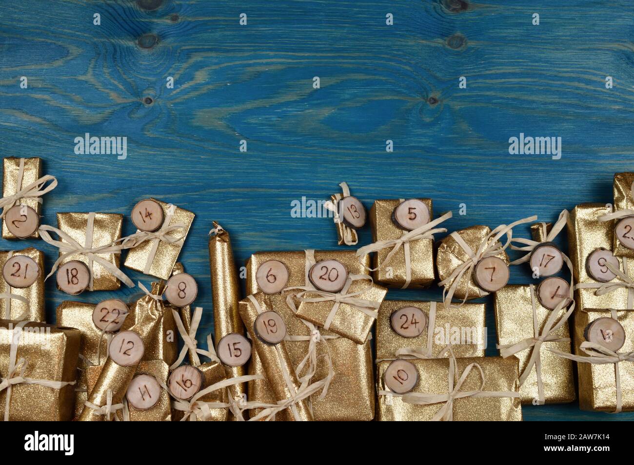 Border of advent calendar with twenty four golden presents on teal wood ...