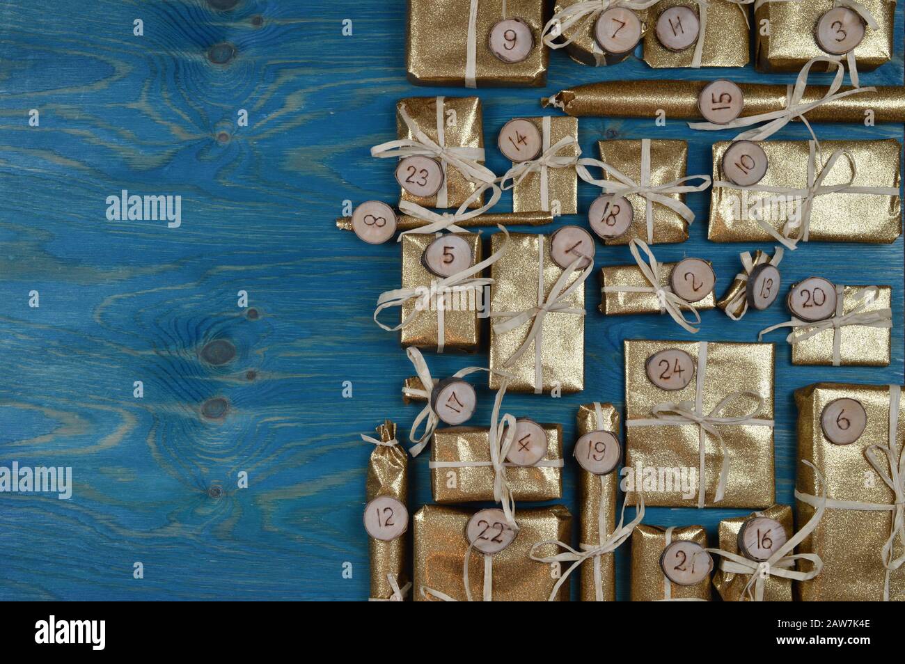 Border of advent calendar with twenty four golden presents on teal wood ...