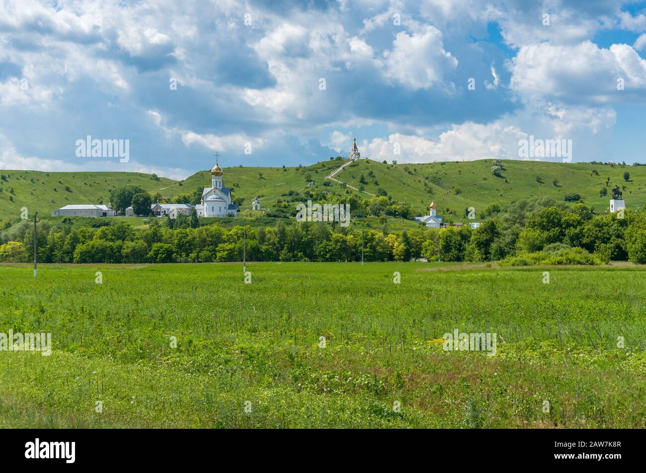 Nature landscape with green grass meadow and churches of Christian ...