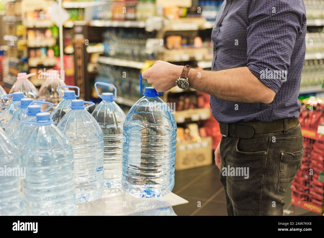 Man pick gallon bottle of drinking or distilling water at the shopping ...