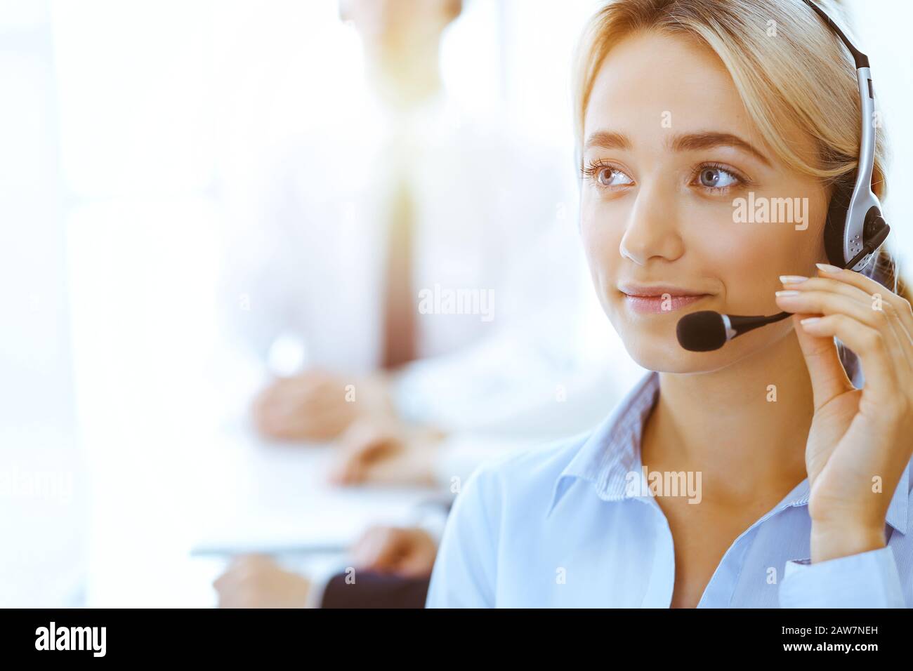 Group of diverse phone operators at work in sunny office. Handsome ...