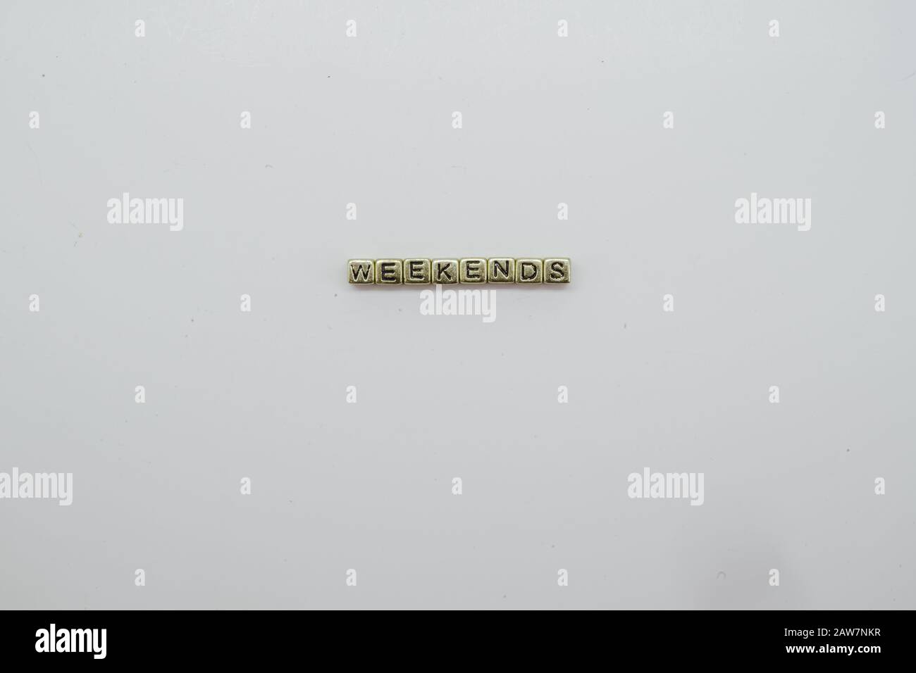 WEEKENDS word made with gold coloured blocks Stock Photo - Alamy