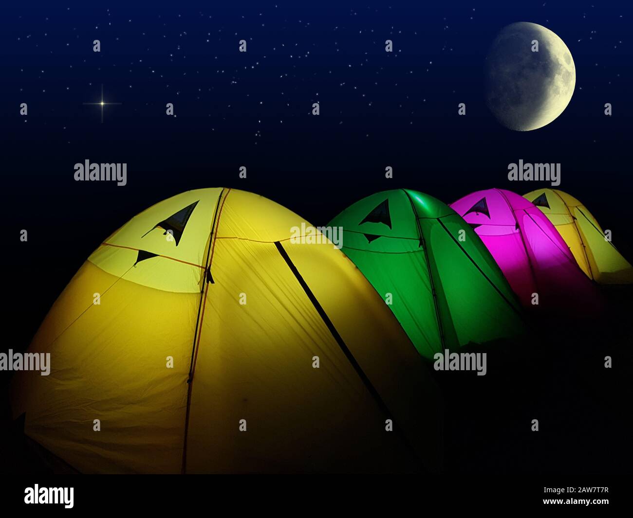 colorful tent glows under a night sky with moon and full of stars ...