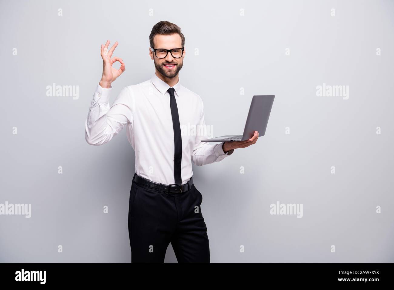 Joyful confident cool man real estate agent smm work his laptop approve ...