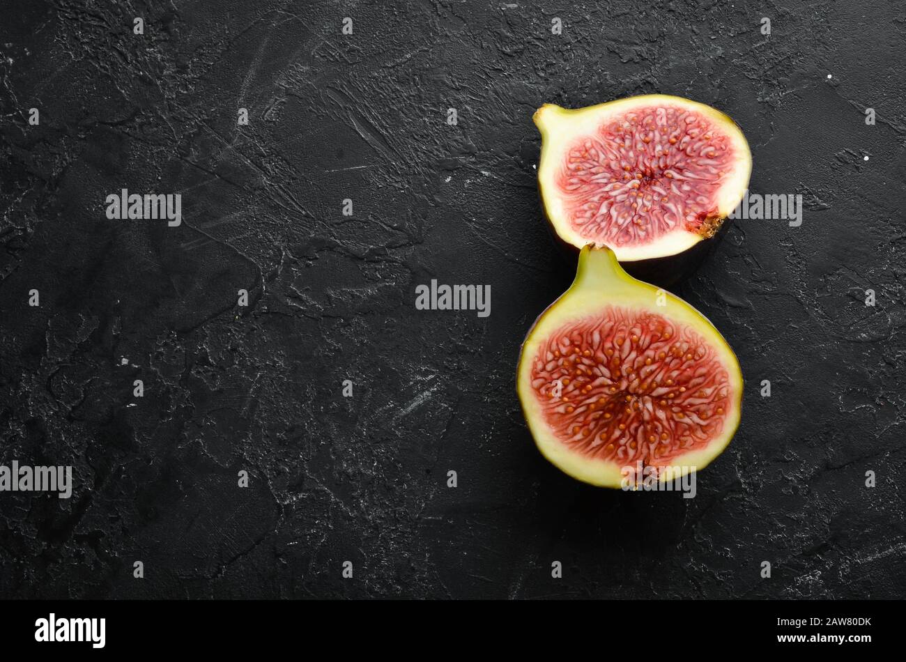 Fresh figs on black stone background. Tropical fruits. Top view. Free ...