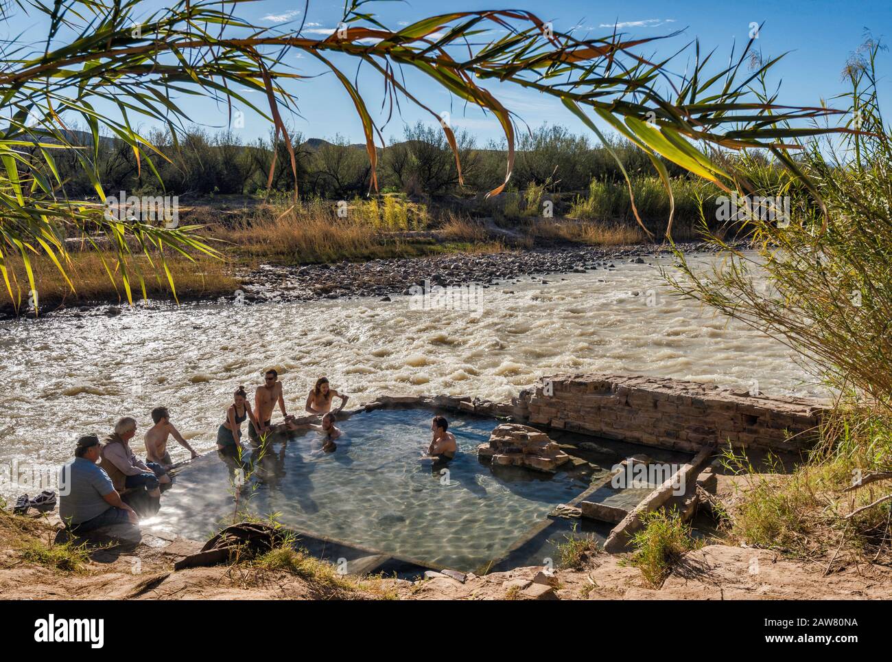 Bathers at Hot Springs pool on edge of Rio Grande, Mexican side across ...