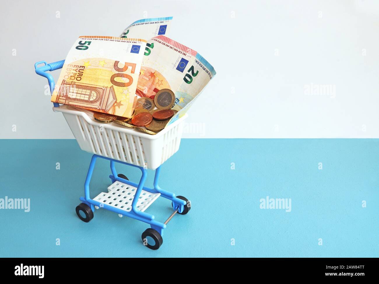 toy supermarket trolley filled with euro bank notes and coins Stock ...