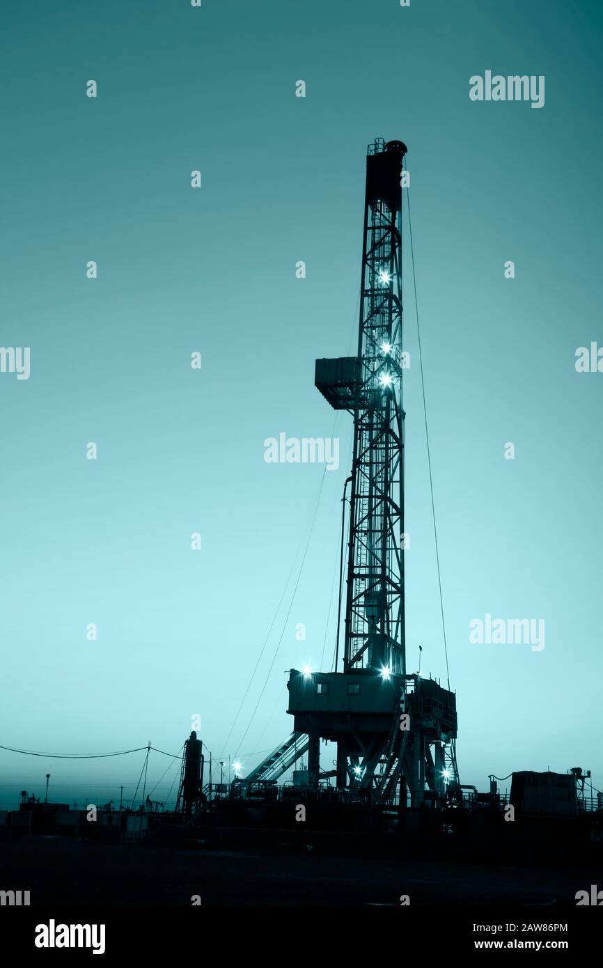 In the evening of oilfield derrick Stock Photo - Alamy