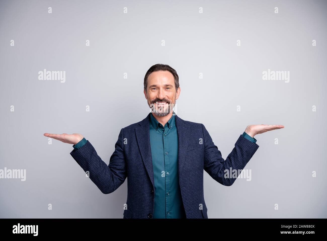 Photo of handsome sales manager worker man advising hold two products ...