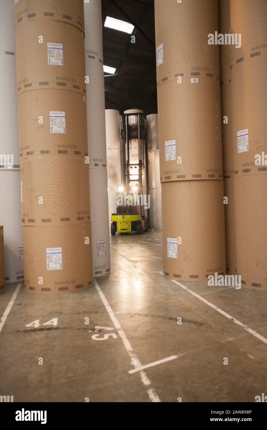 Paper rolls stacked in warehouse Stock Photo - Alamy