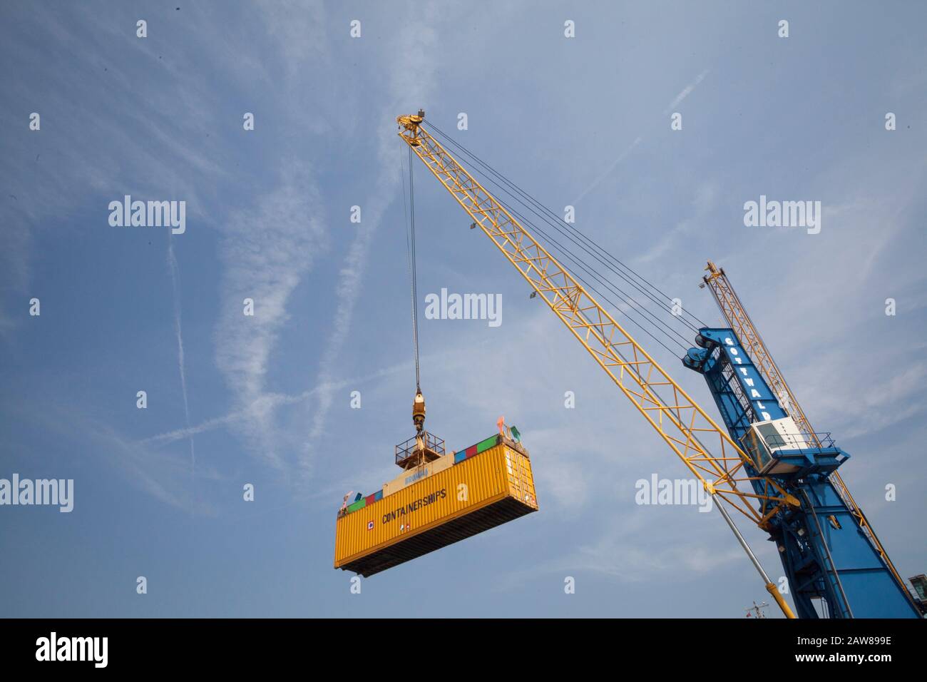 Dock crane loading and unloading a container from a container ship ...