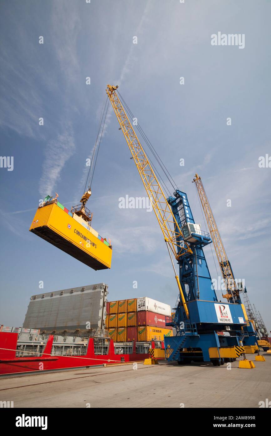 Dock crane loading and unloading a container from a container ship ... Dock crane loading and unloading a container from a container ship ...