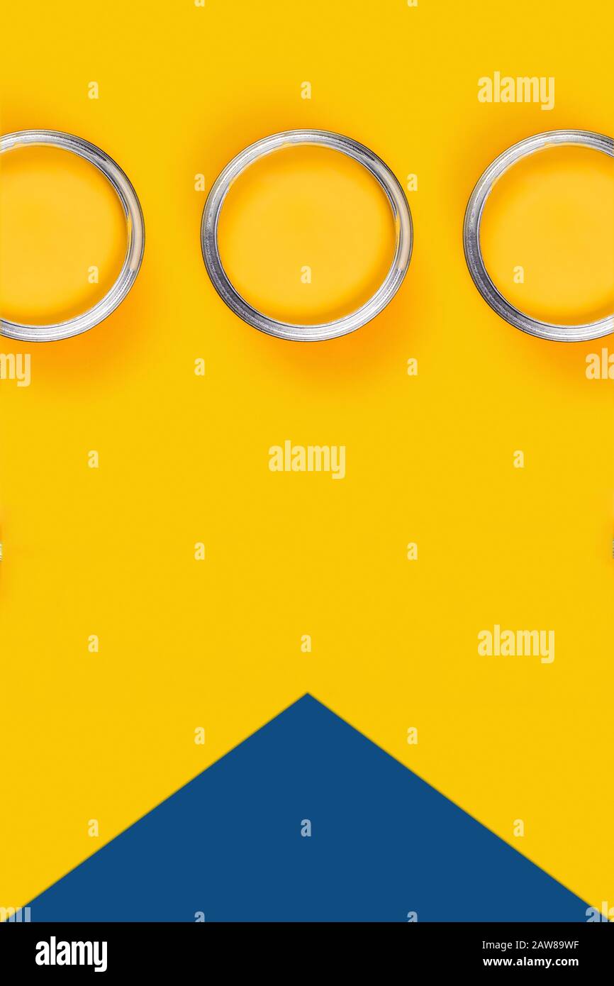Repair concept. Yellow background with three paint cans. Flat lay, top ...