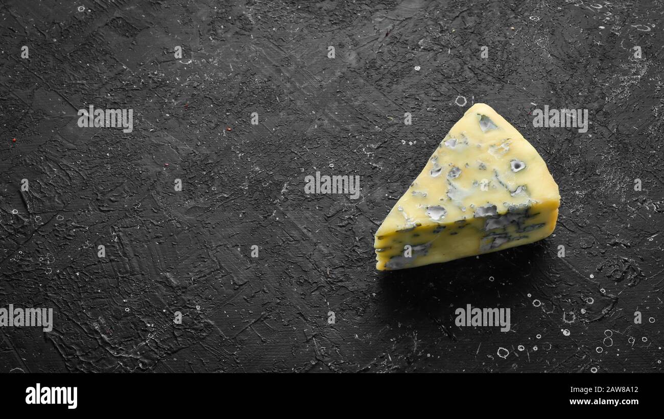 Blue cheese with mold on black background. Top view. Free space for ...
