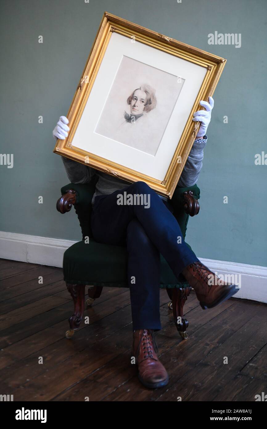 A man holds an unfinished portrait of Charles Dickens by Samuel ...