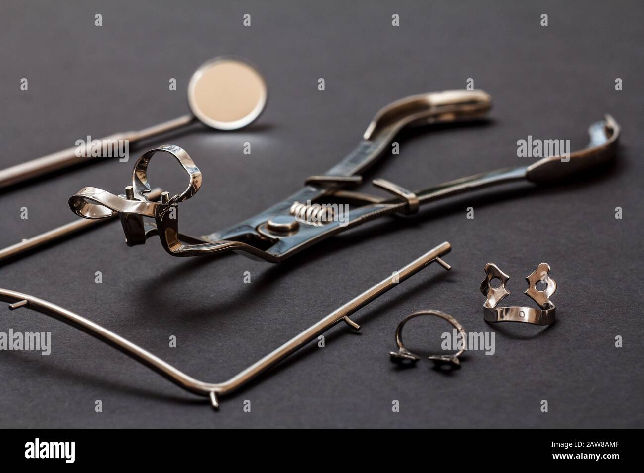 Set of metal dental instruments for dental treatment. Dental mirror ...