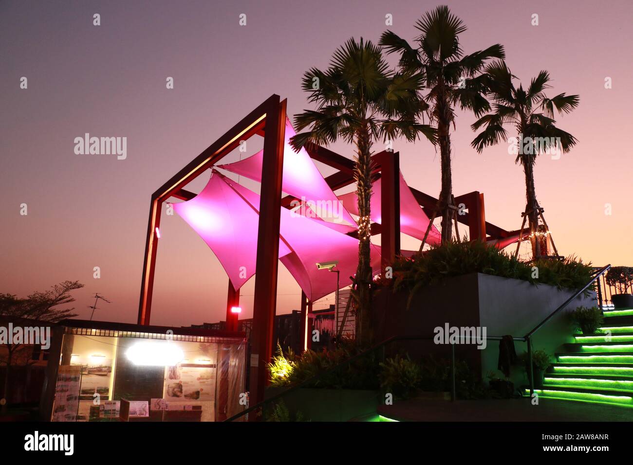 a modern tropical roof structure with palm trees and stairway against ...