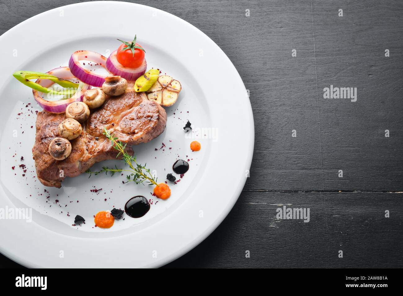 Grilled pork steak with sauce on a plate. Top view. Free copy space ...