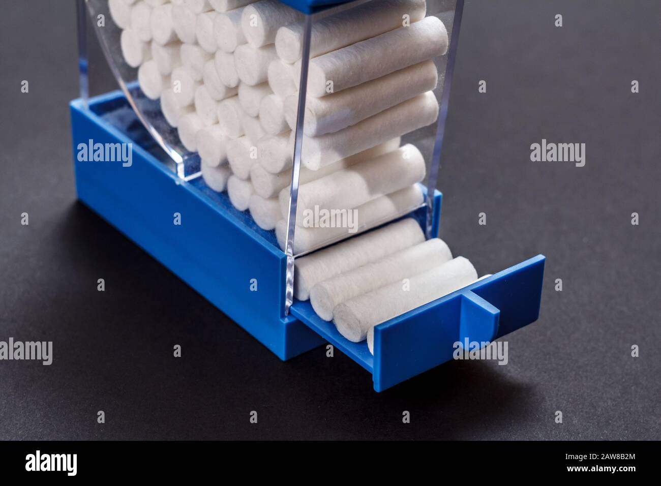 Plastic box with cotton tampons on black background. Medical tools ...