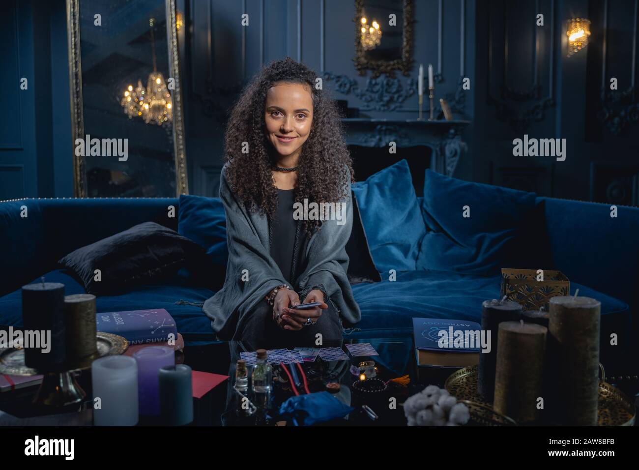 Cheerful young fortune-teller smiling at the camera Stock Photo - Alamy