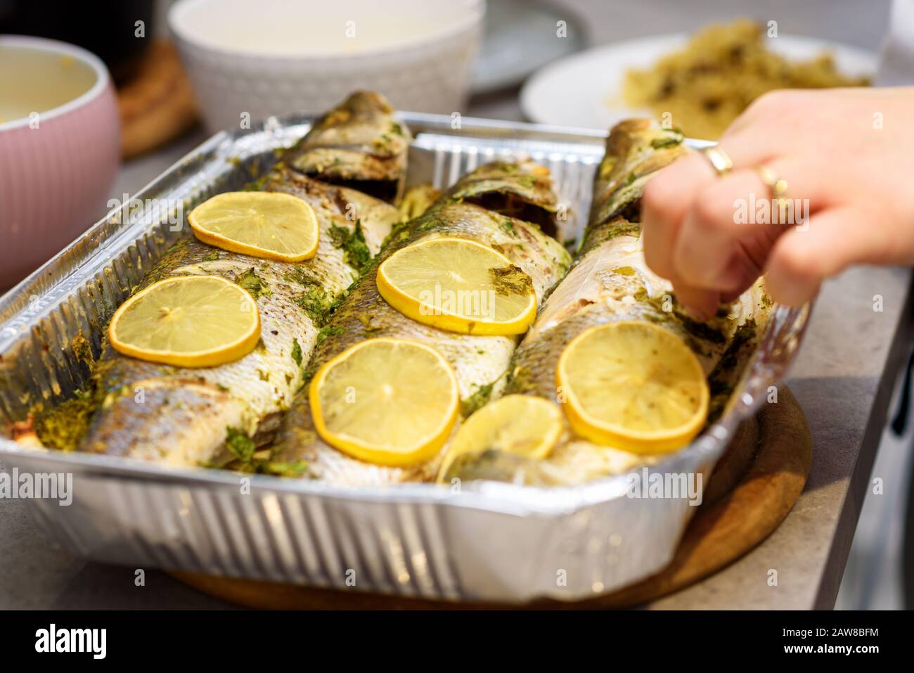 Whole roasted sea bass. Oven baked whole fish with lemon, herbs and ...
