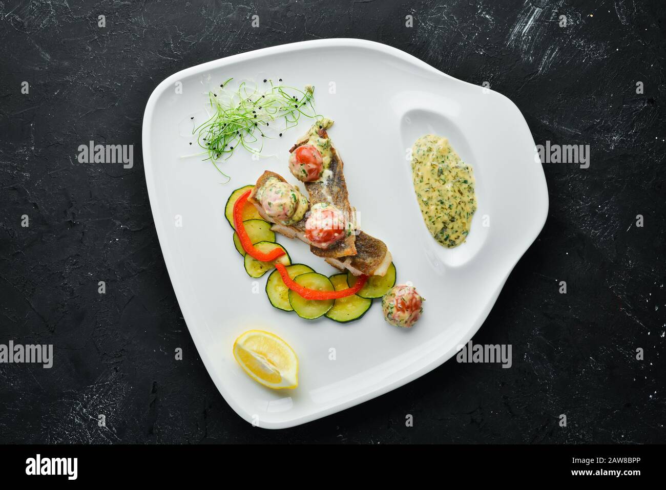 Baked fish fillet with vegetables. Top view. Free space for your text ...