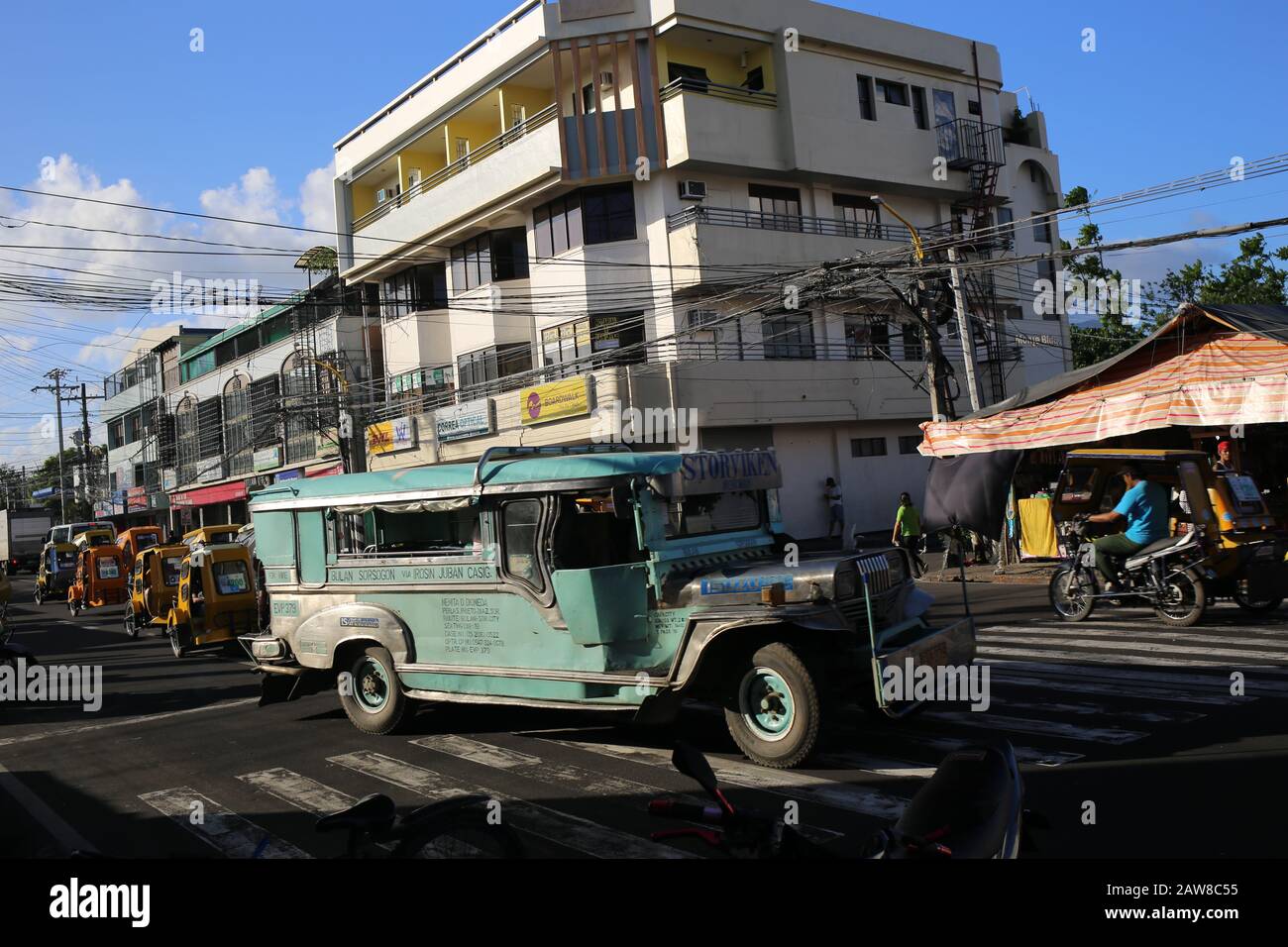 Blue jeepney driving down the street in The Philippines Stock Photo - Alamy