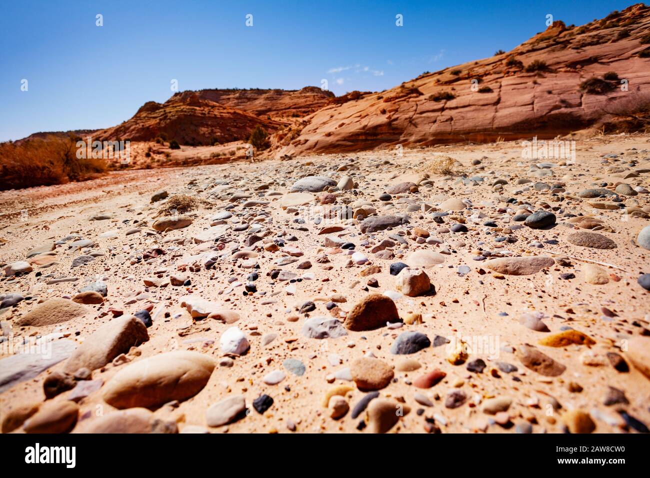 Rocks and sand on the dry river bed in the Utah desert near the Zebra ...