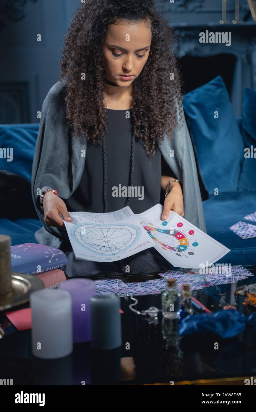 Focused young female astrologer casting a horoscope Stock Photo - Alamy