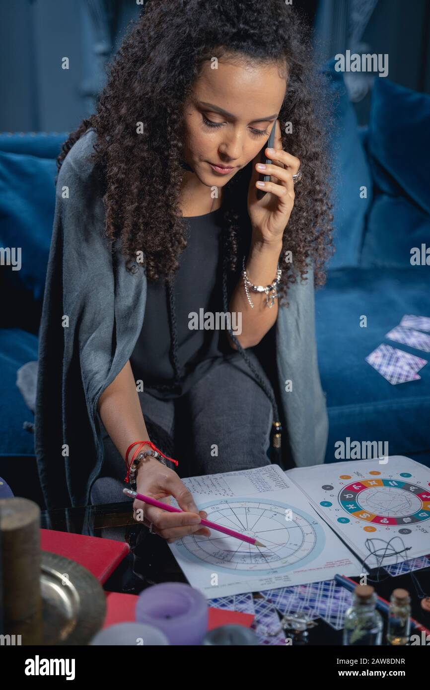 Serious young woman interpreting a birth chart Stock Photo - Alamy Serious young woman interpreting a birth chart Stock Photo - Alamy