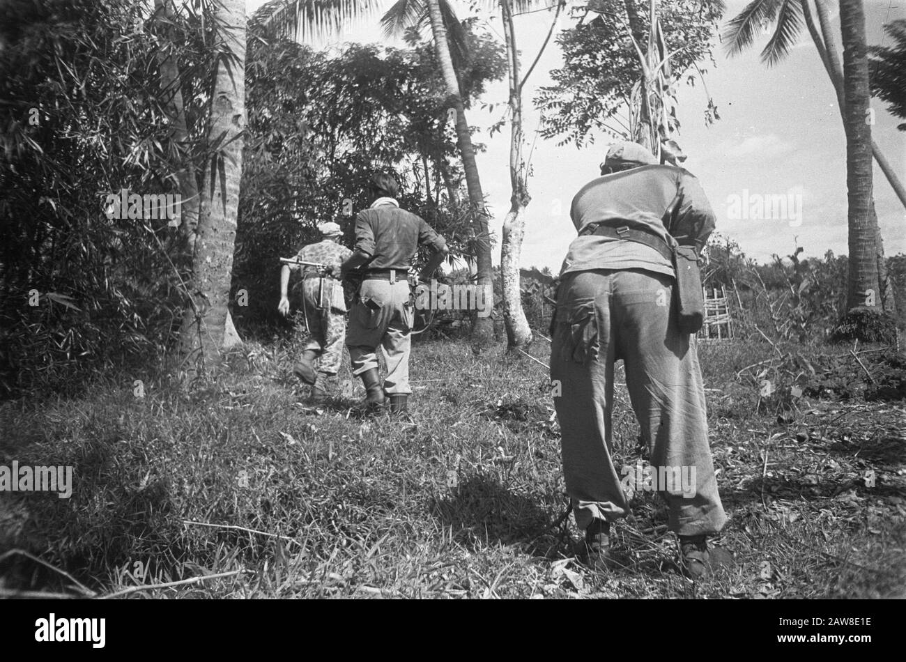 Operation near Keboemen, Tjilatjap Patrol. Three soldiers moving ...