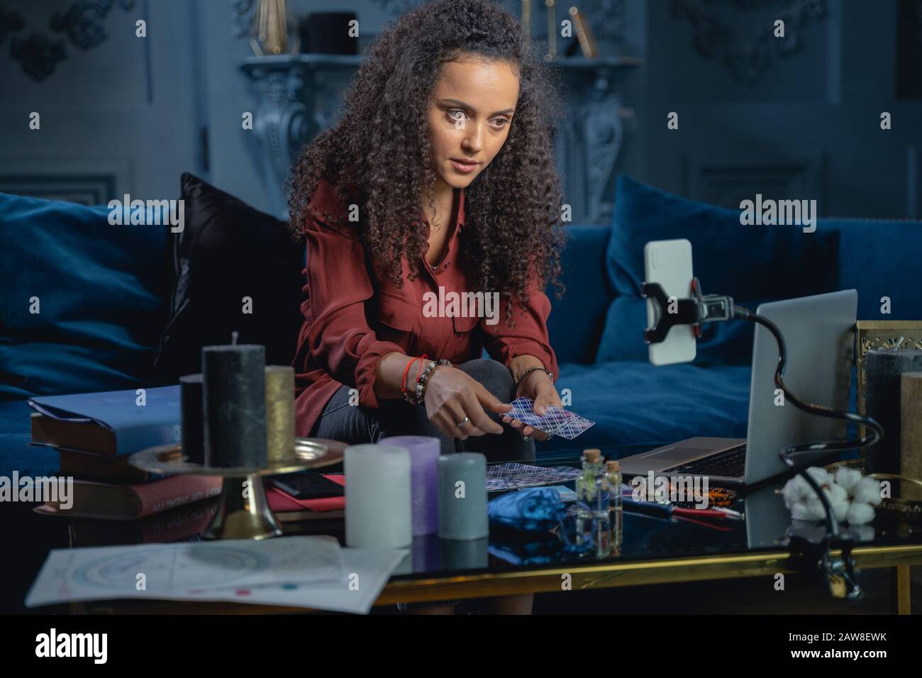 Modern young fortune-teller cutting the tarot cards Stock Photo - Alamy