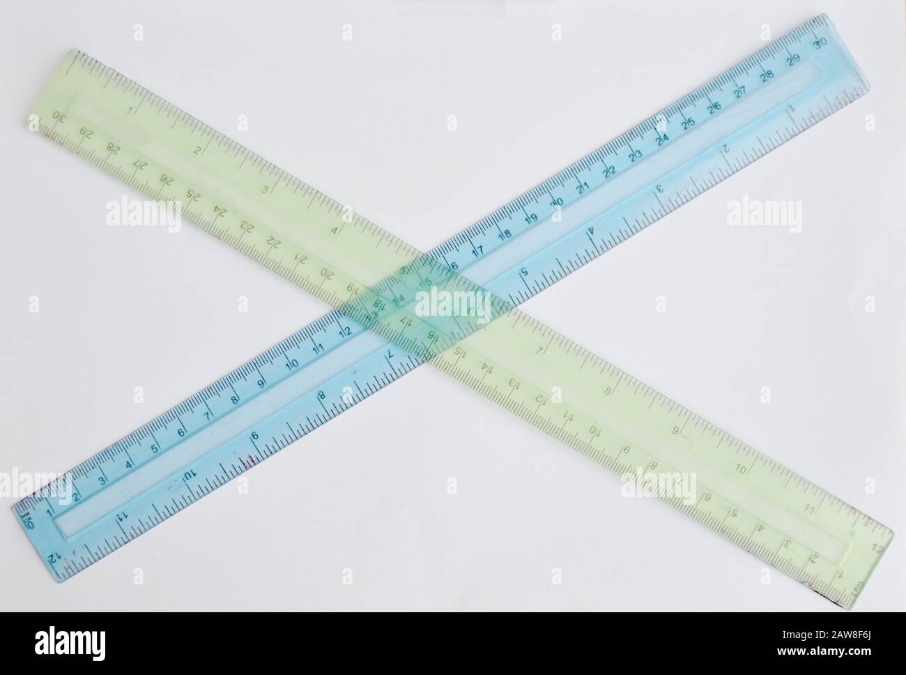 colorful plastic ruler crossing on white background Stock Photo - Alamy