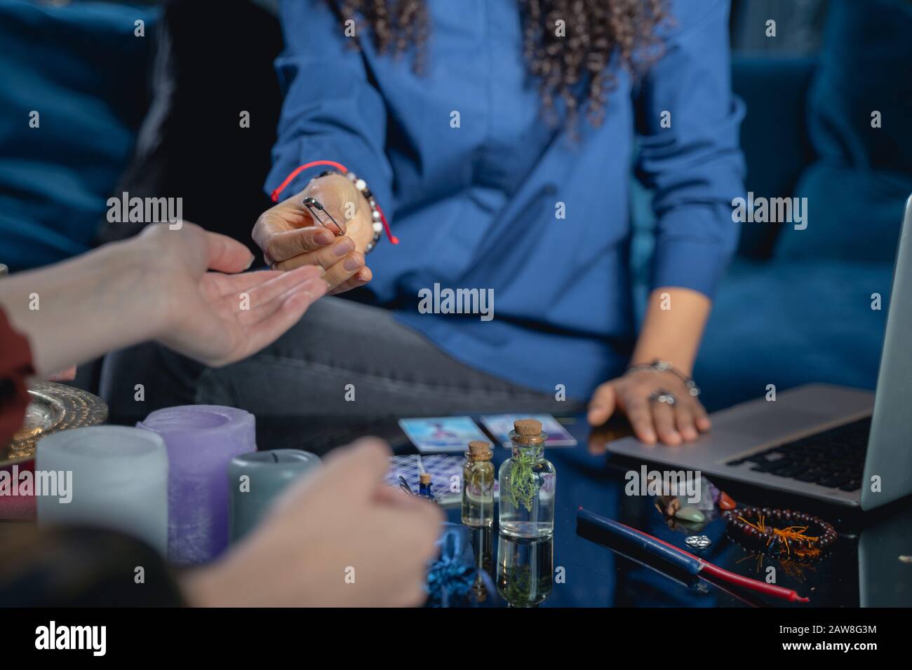 Witch giving an amulet to a woman Stock Photo - Alamy