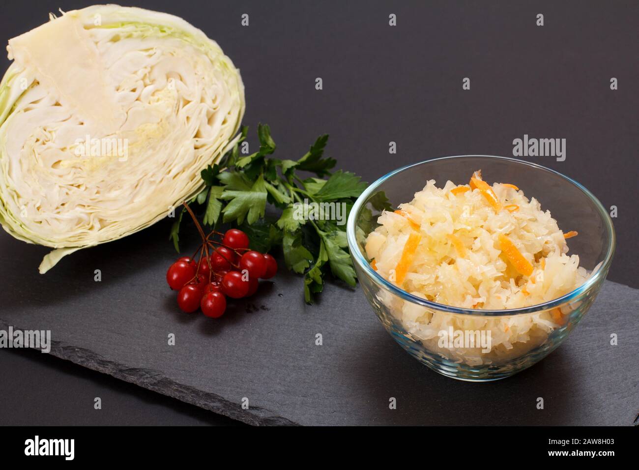 Homemade fermented cabbage with carrot in glass bowl. Fresh head of ...