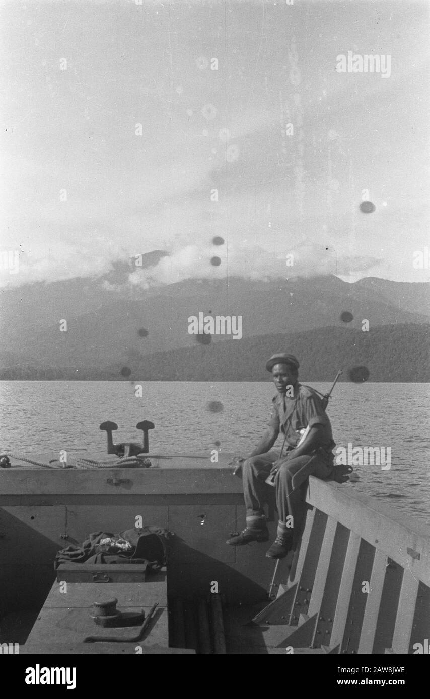 New Guinea Series [KNIL soldier sitting on the railing of a landing ...