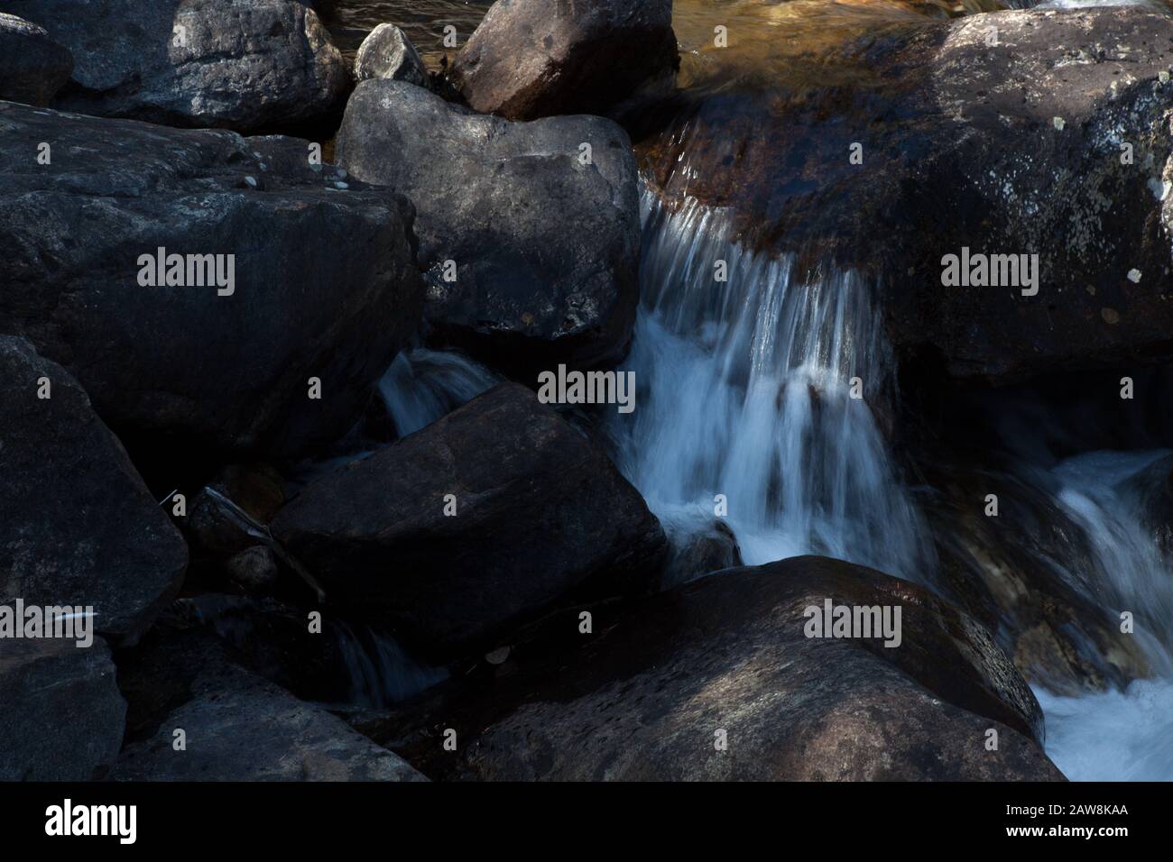 Natural waterfall over rocks outdoors Stock Photo - Alamy