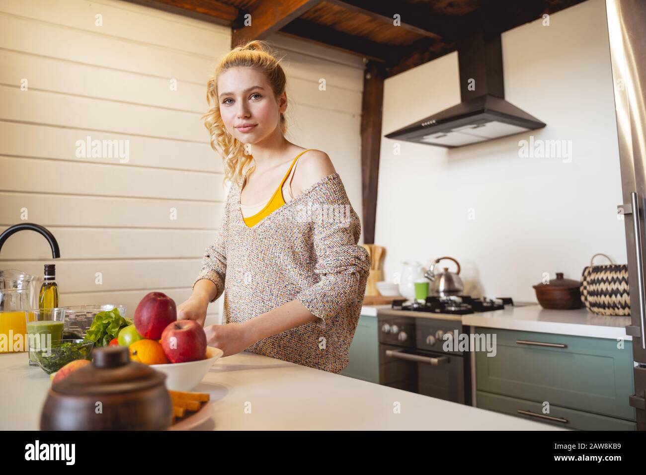 Charming young blonde girl cooking healthy dinner Stock Photo - Alamy