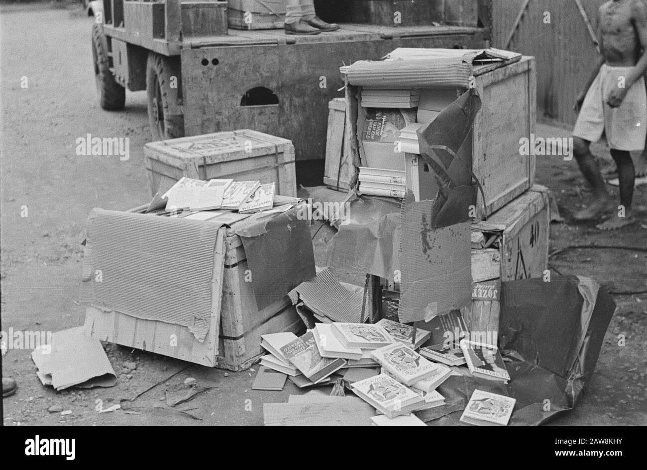 Boxes are unloaded. Some boxes are opened. Books are visible Date ...