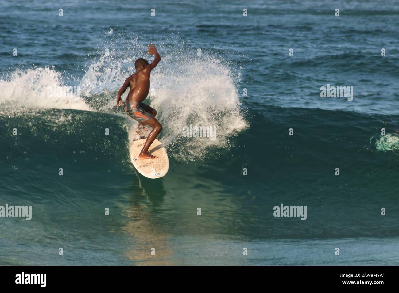 native black african surfer catching a wave Stock Photo - Alamy