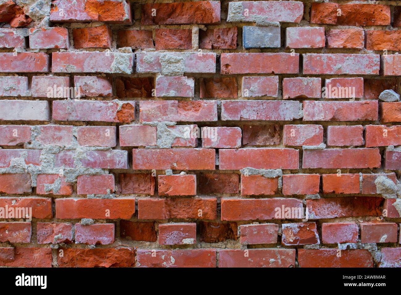 Old broken, damaged and corroded brick wall with broken bricks missing ...