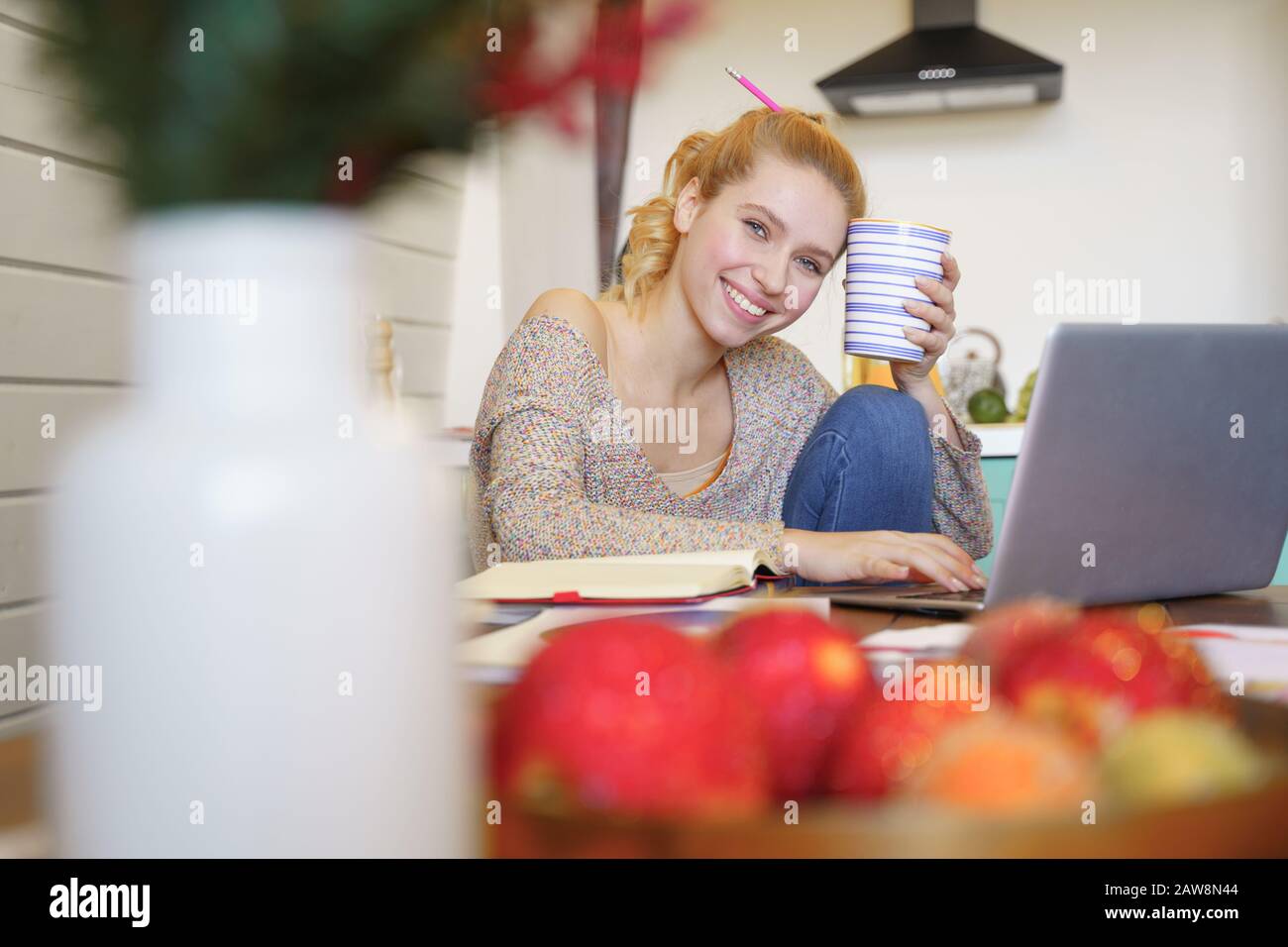 Happy blonde girl working at home alone Stock Photo - Alamy