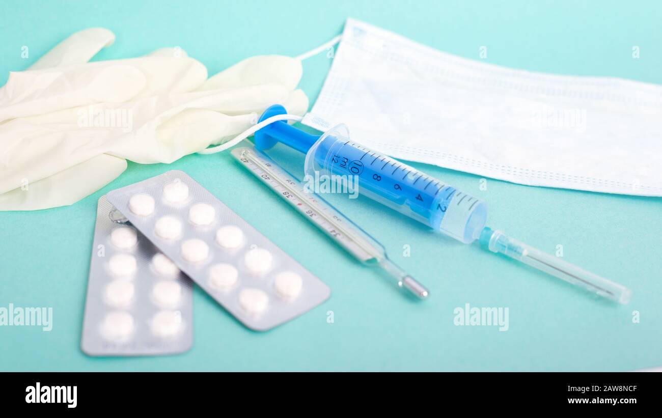 cold protection medical supplies on a blue background. mask respirator ...