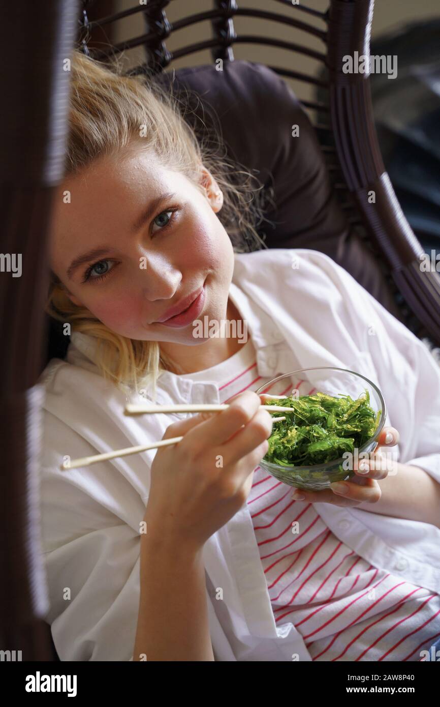 Portrait of relaxed girl that eating algae Stock Photo - Alamy