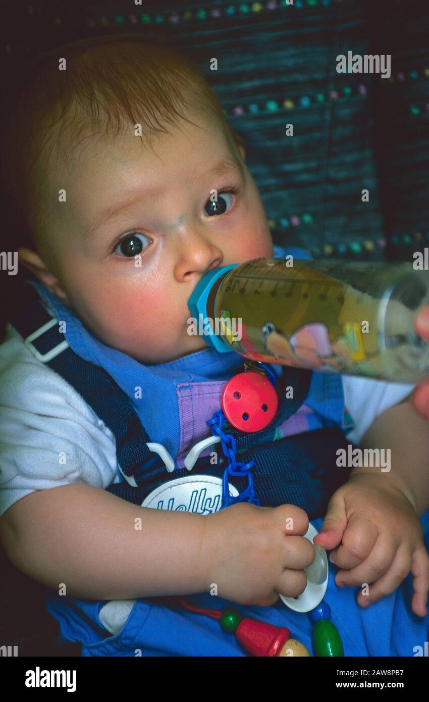 portrait of a baby boy drinking from his bottle Stock Photo - Alamy