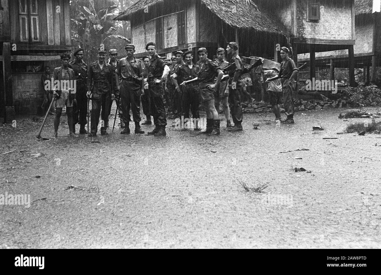 Dutch soldiers posing in a kampong during a heavy rainstorm Annotation ...